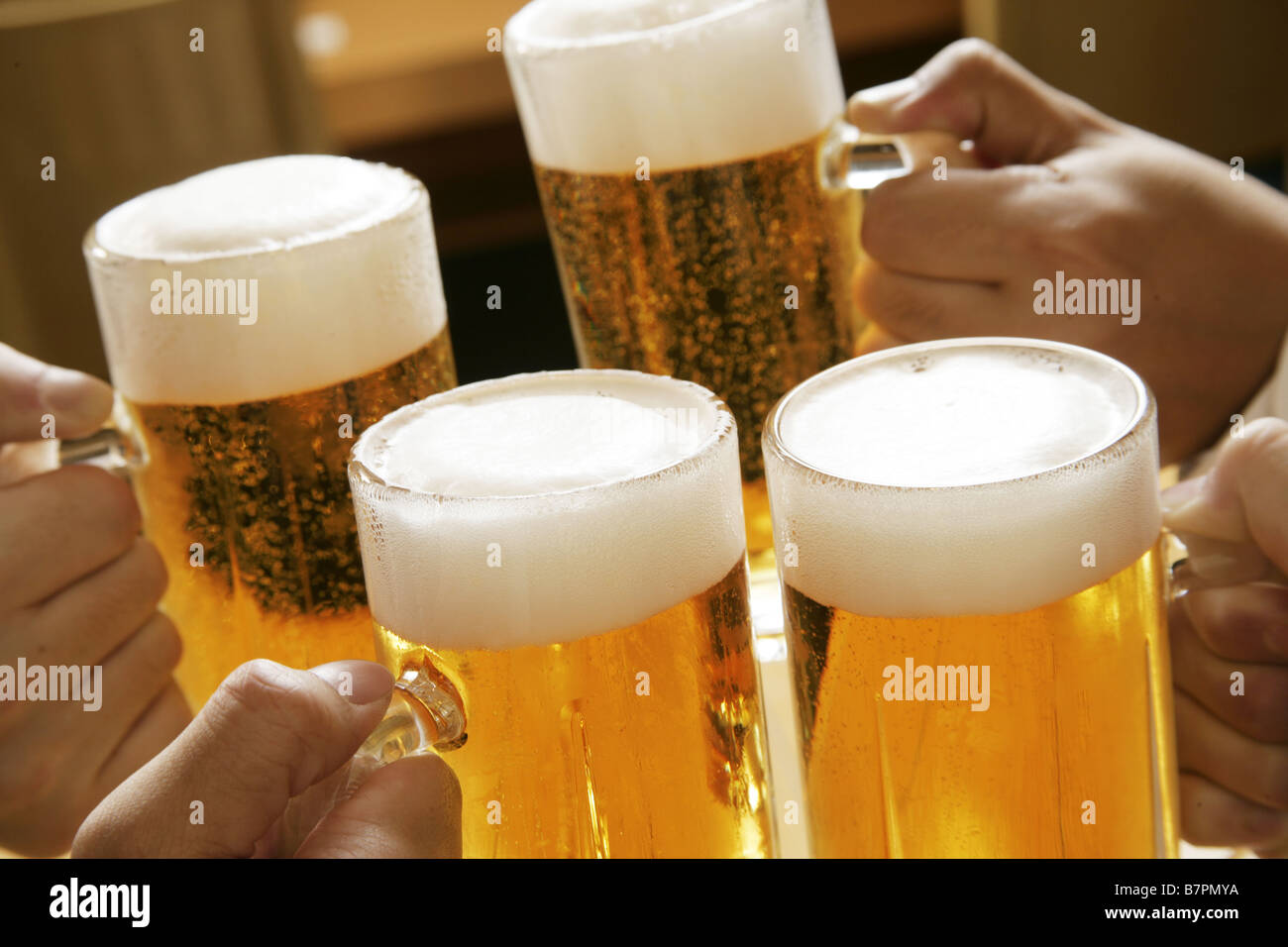 Making a toast with beer Stock Photo - Alamy