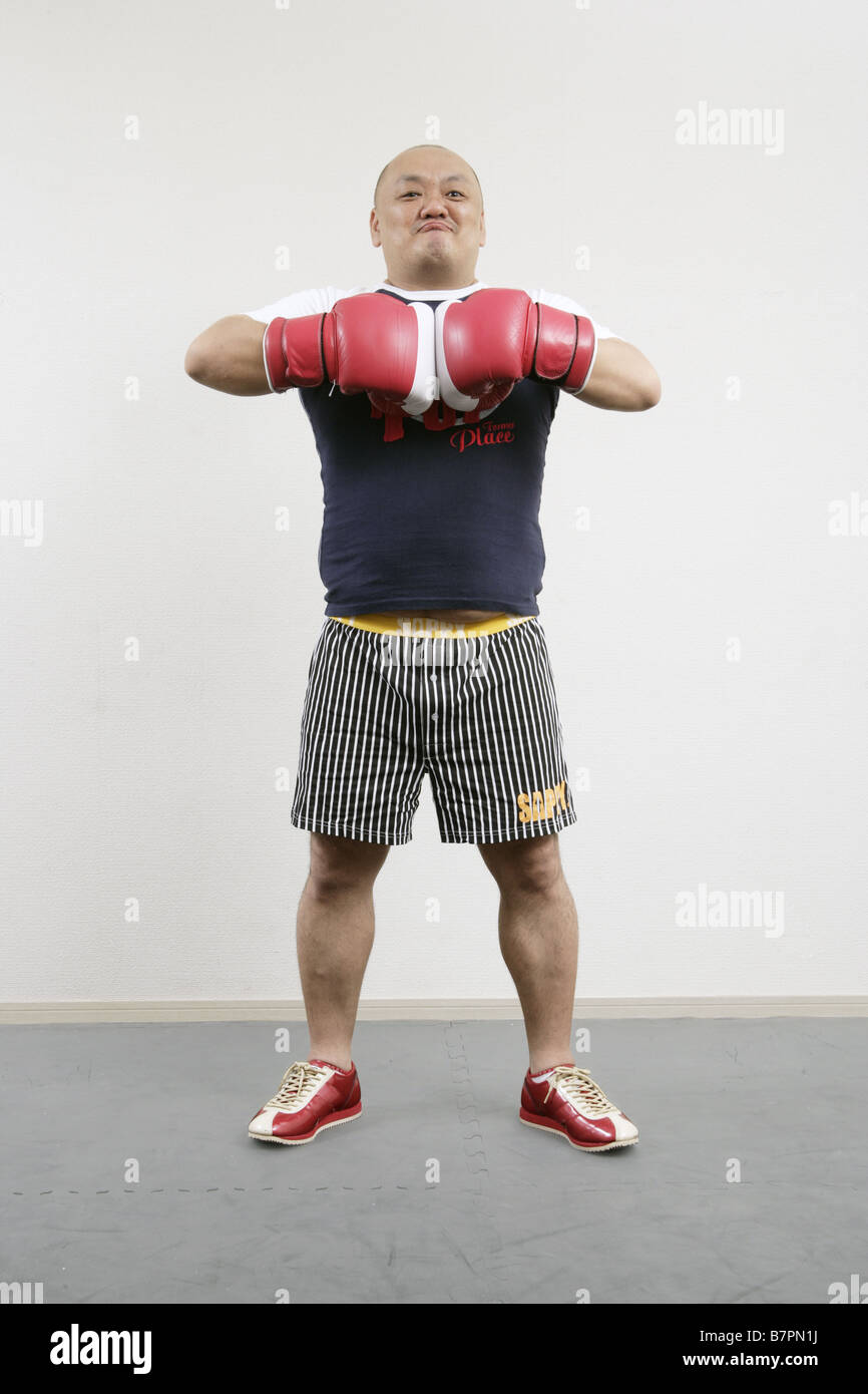 A man wearing boxing gloves Stock Photo - Alamy
