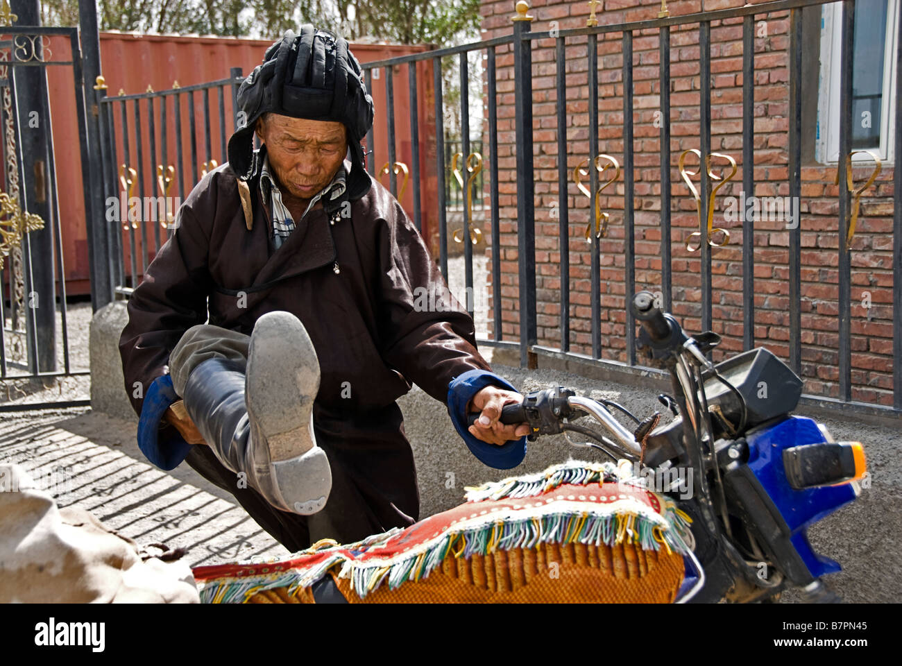 Old man trying to ride a motorcycle, Gobi desert, Mongolia Stock Photo ...