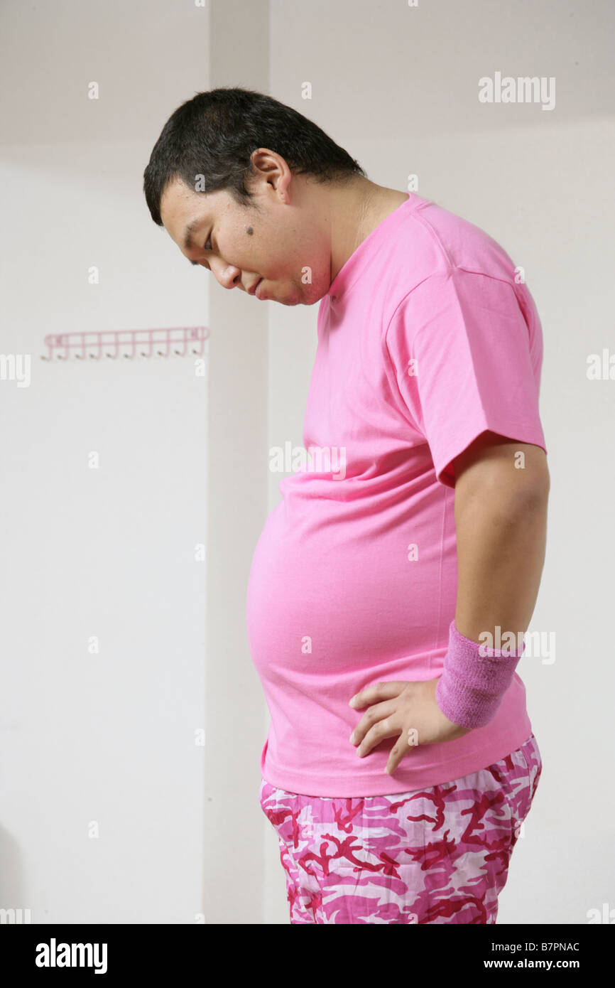 A man watching his belly Stock Photo - Alamy