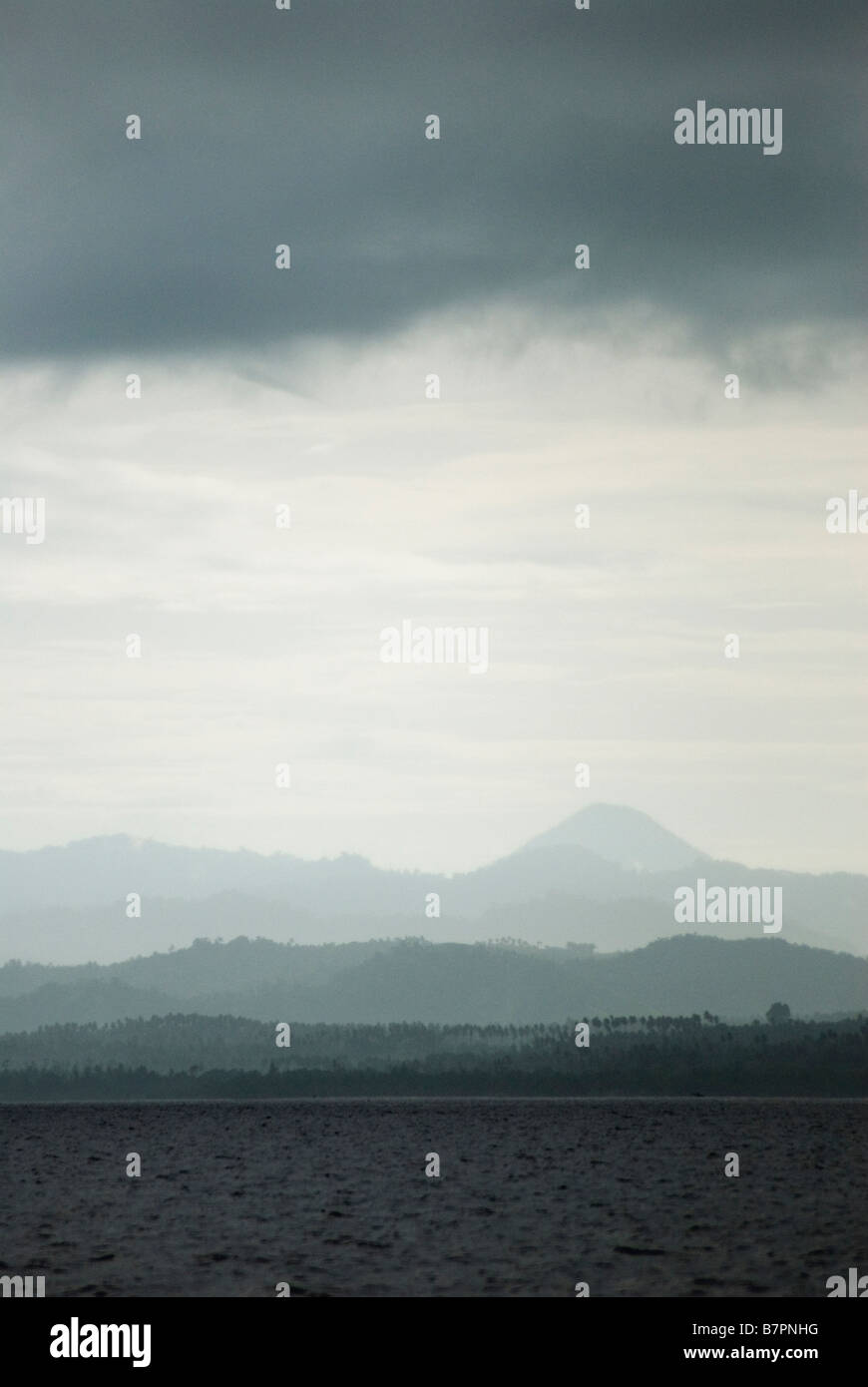 Mount Klabat, highest in Northern Sulawesi rises above the dawn mist of ...