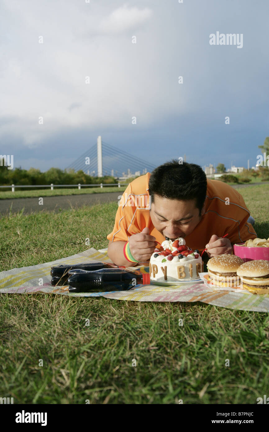 A man eating a cake Stock Photo - Alamy