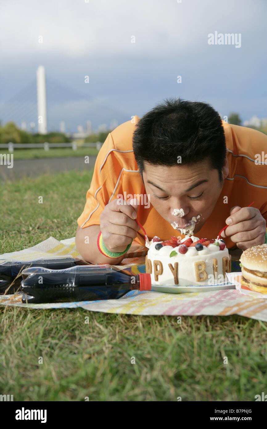 A man eating a cake Stock Photo - Alamy