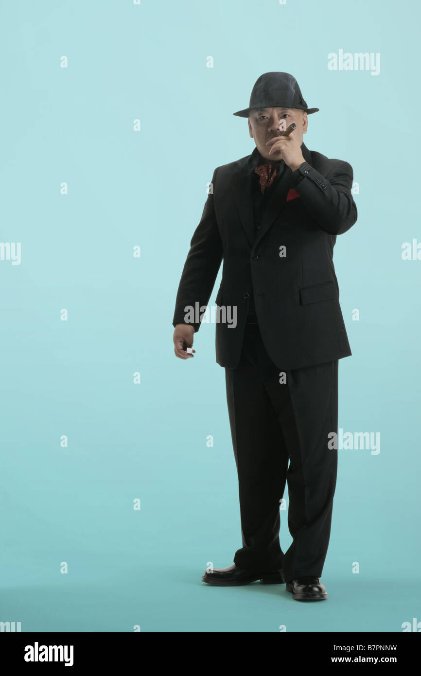 A man in suit smoking a cigar Stock Photo - Alamy