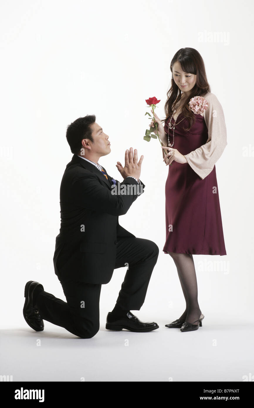 Man presenting flower woman hi-res stock photography and images - Alamy