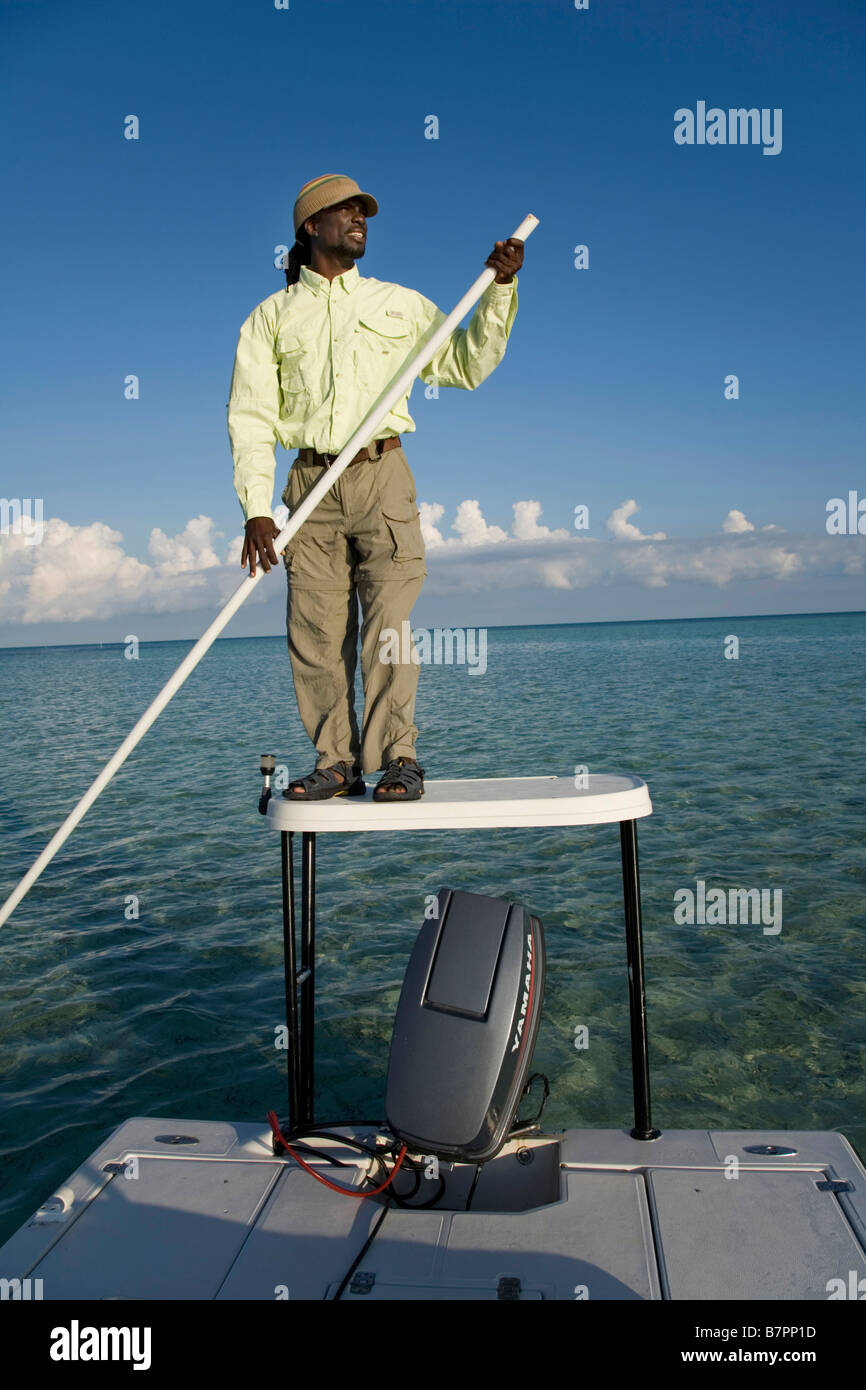 Bonefishing guide Shawn Leadon poles his boat in shallow waters near ...