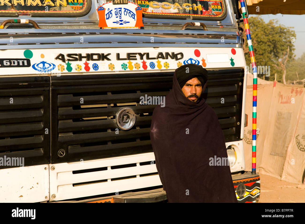 An Indian truck driver, one of a few million trucks moving around India ...
