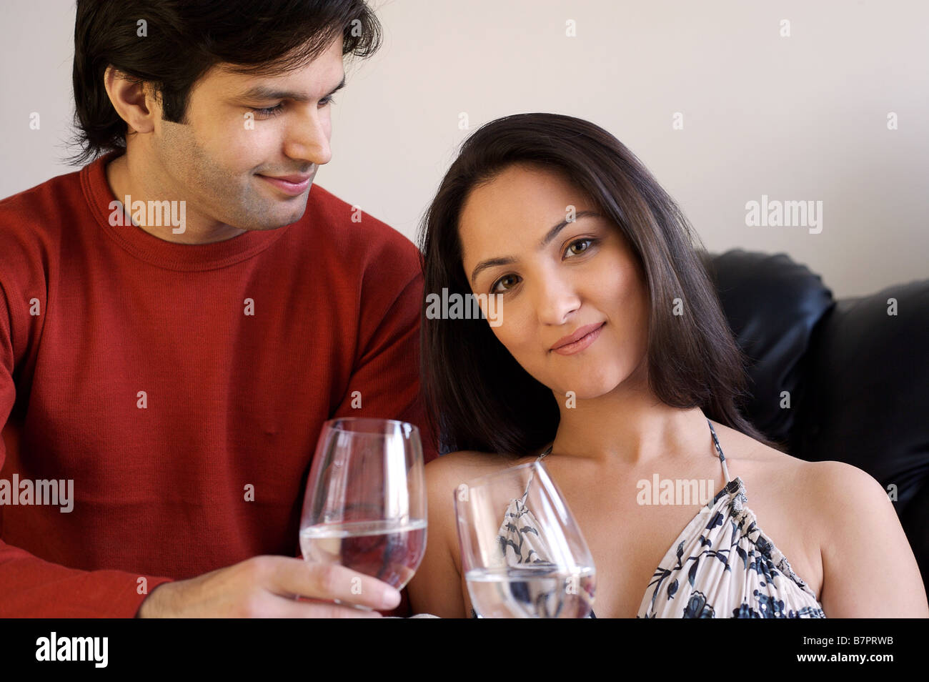 Young happy couple raising toast hi-res stock photography and images ...