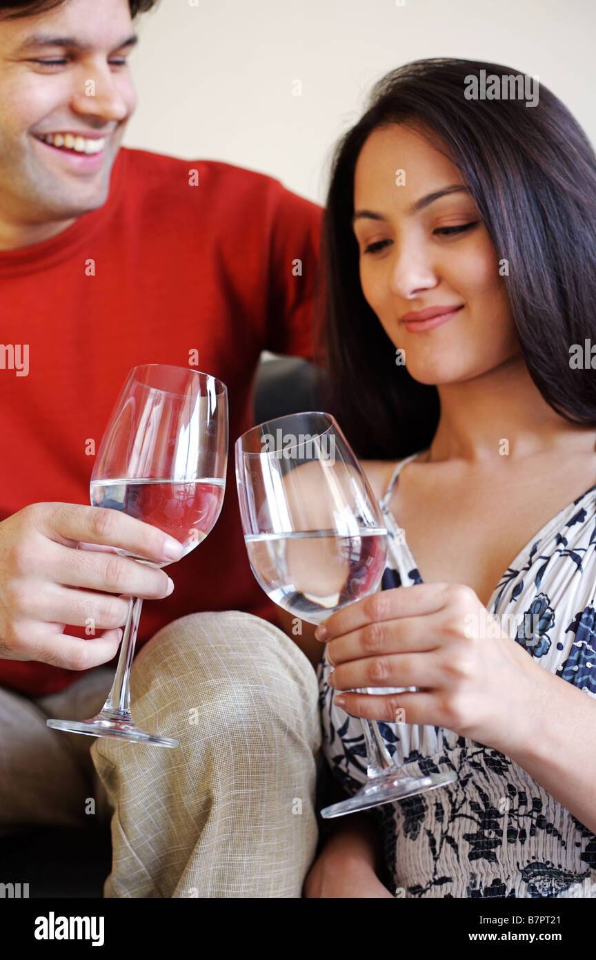 Couple raising toast with champagne Stock Photo - Alamy