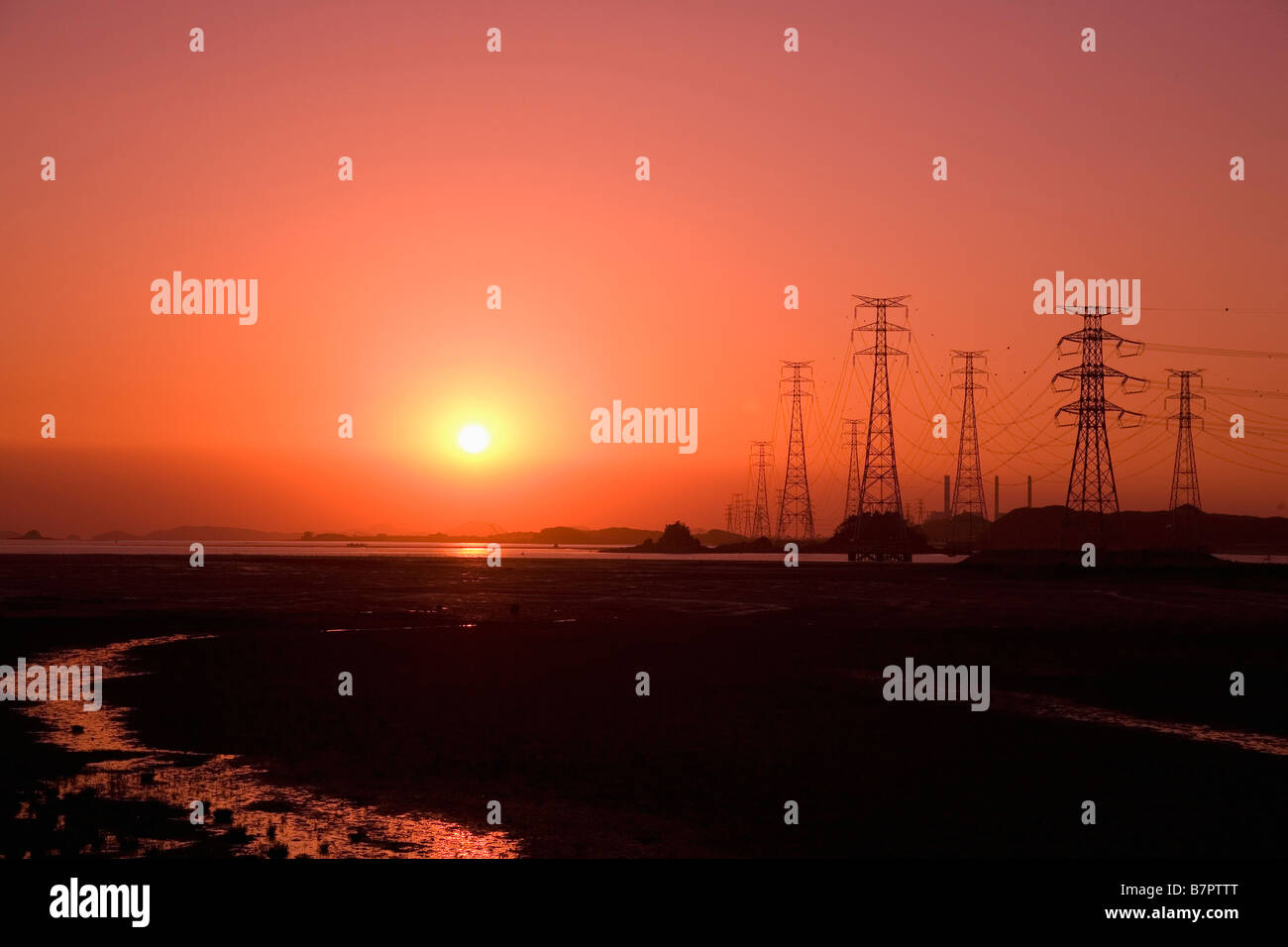 Electric towers at sunset Stock Photo - Alamy