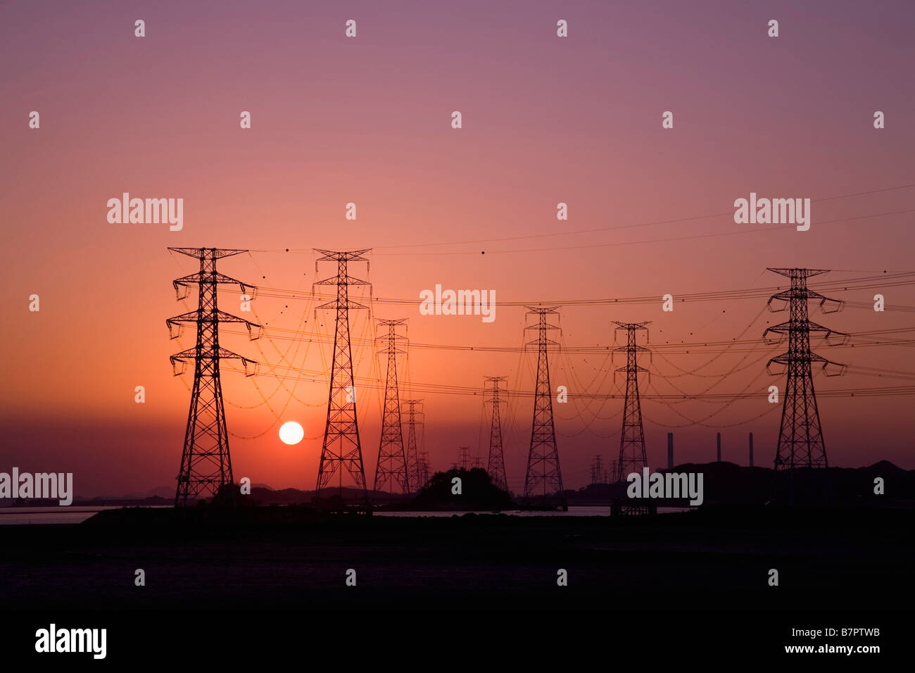Electric towers at sunset Stock Photo - Alamy