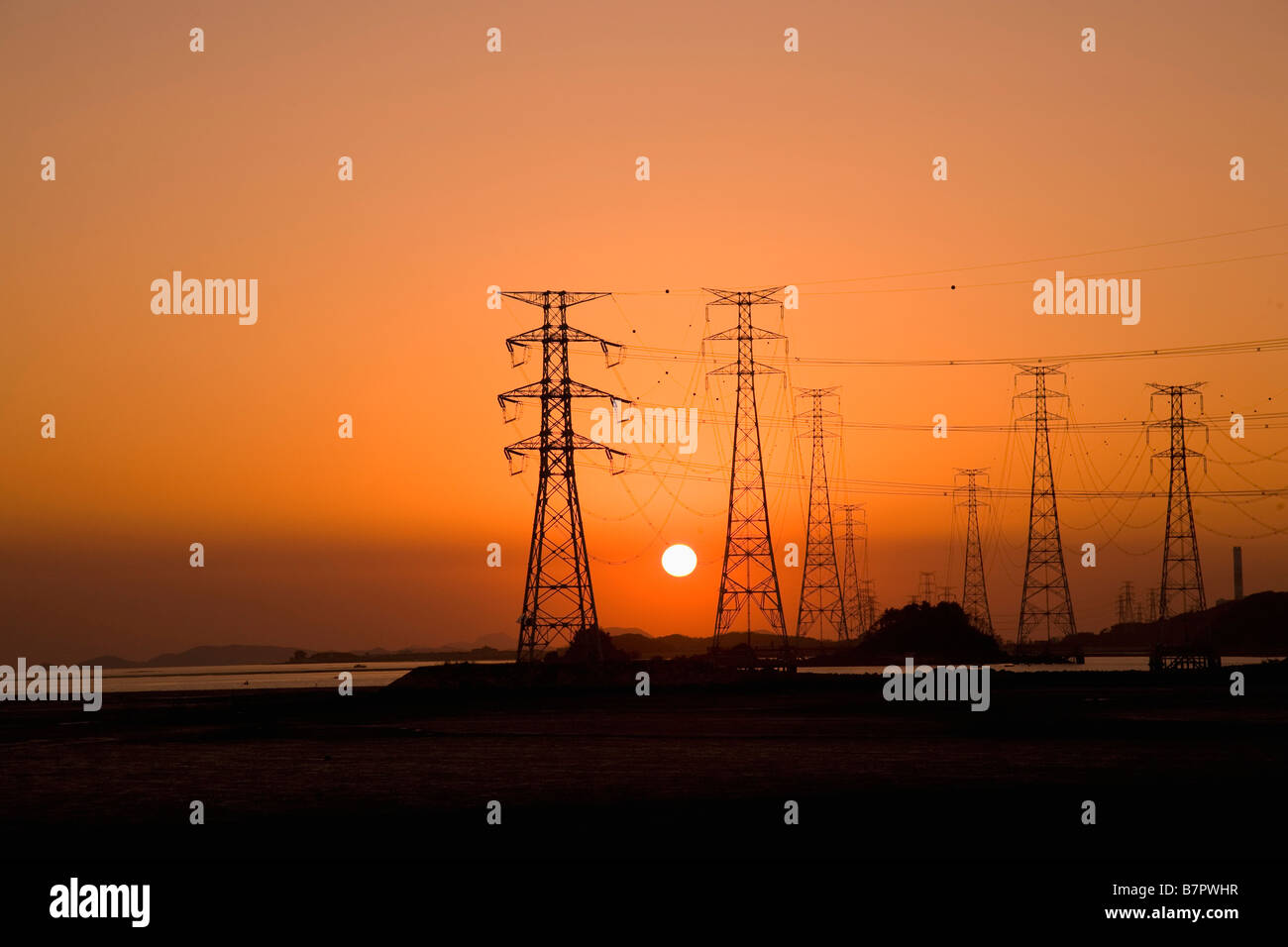 Electric towers at sunset Stock Photo - Alamy