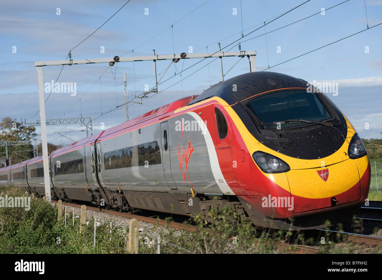 Class 390 Pendolino train speeding along track on the West Coast Main ...