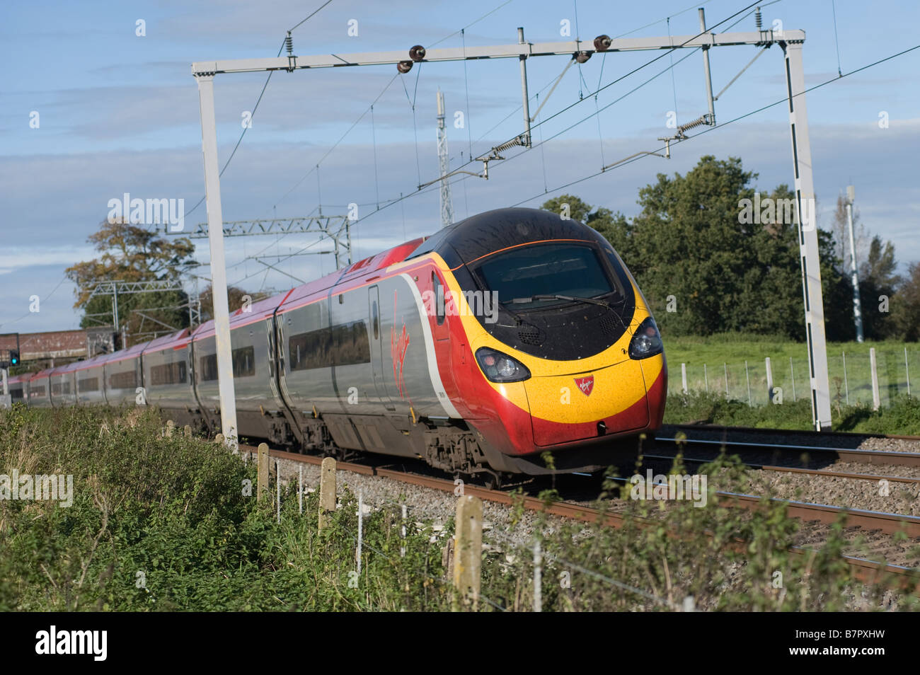 Class 390 Pendolino train speeding along track on the West Coast Main ...