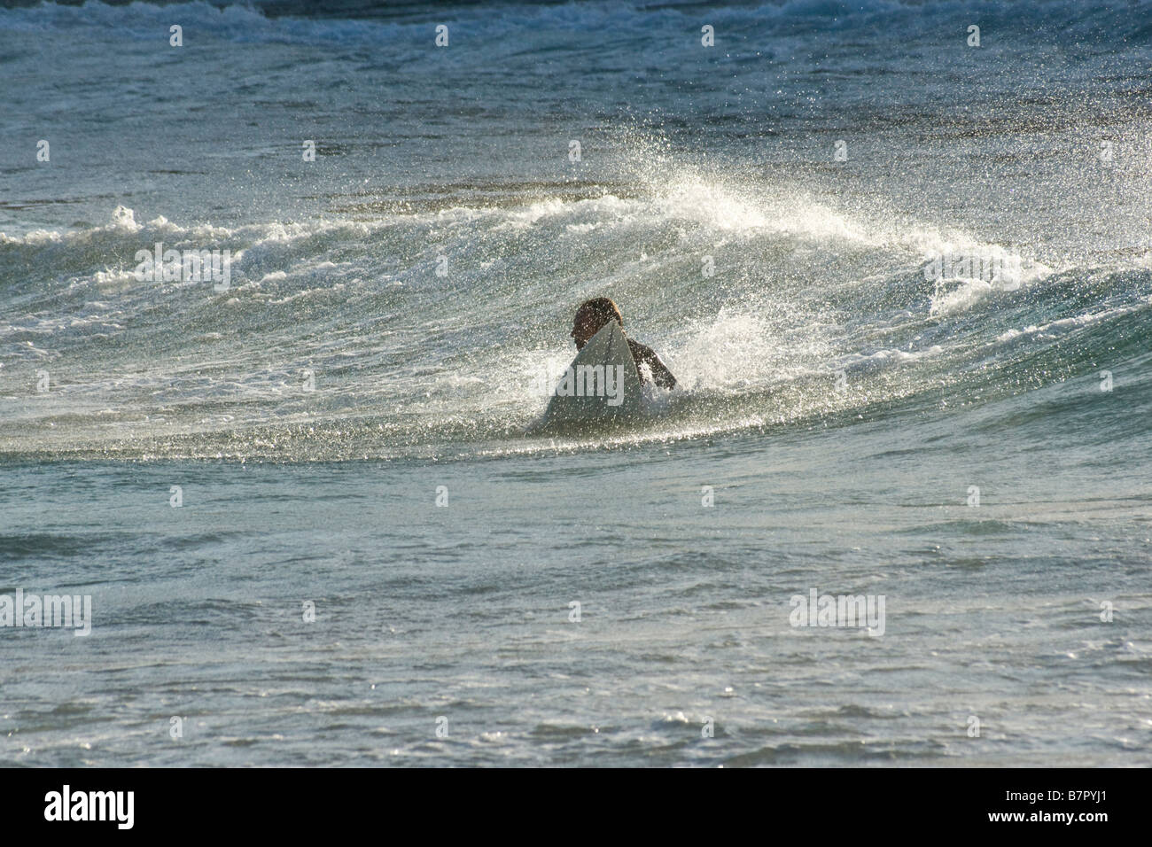 Surfer waiting for wave Stock Photo - Alamy