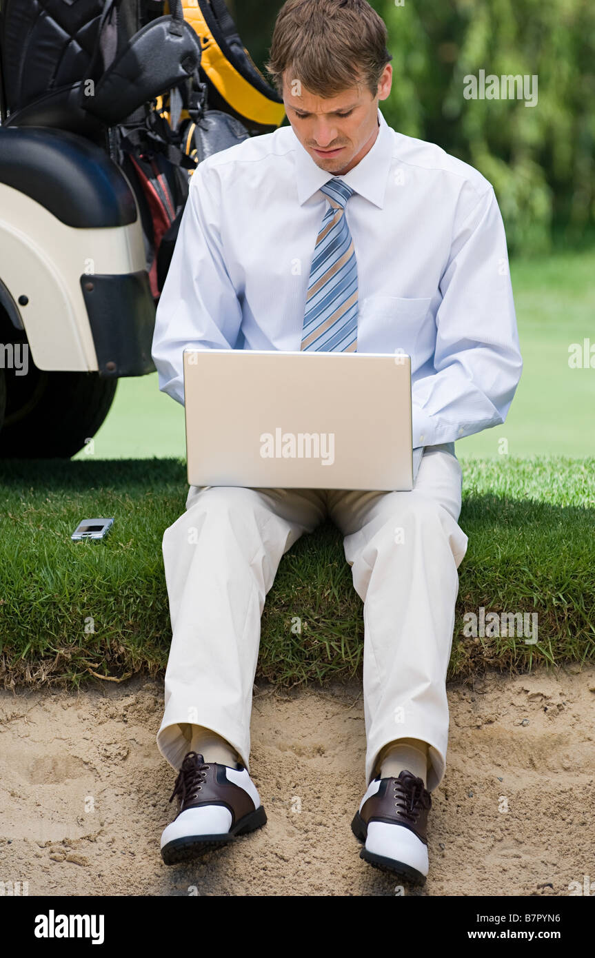 A businessman using a laptop Stock Photo - Alamy