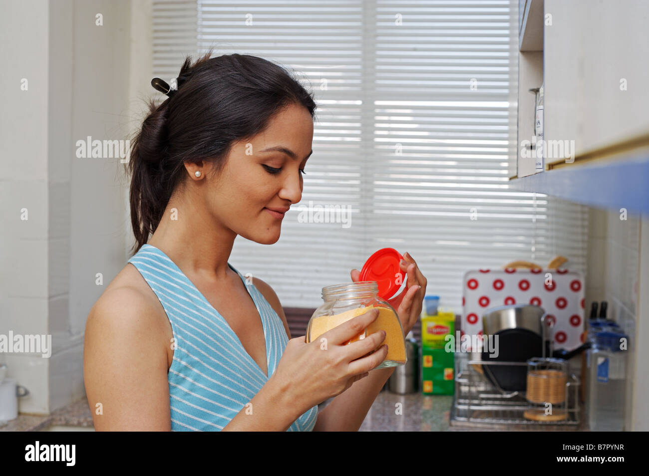 Woman working in a kitchen Stock Photo - Alamy
