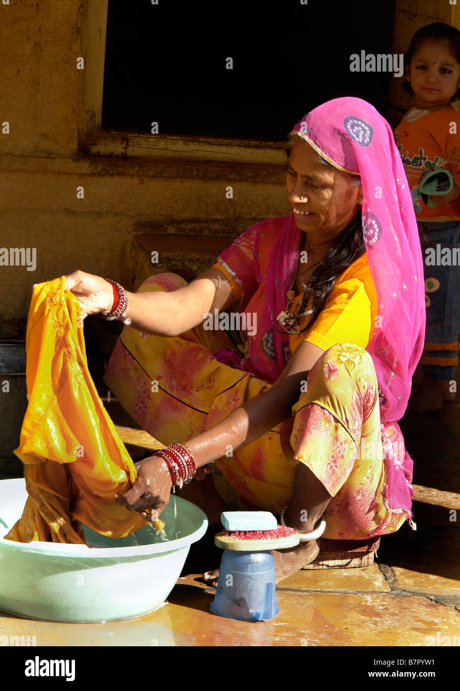 indian woman doing the washing in the back streets of the old city of ...