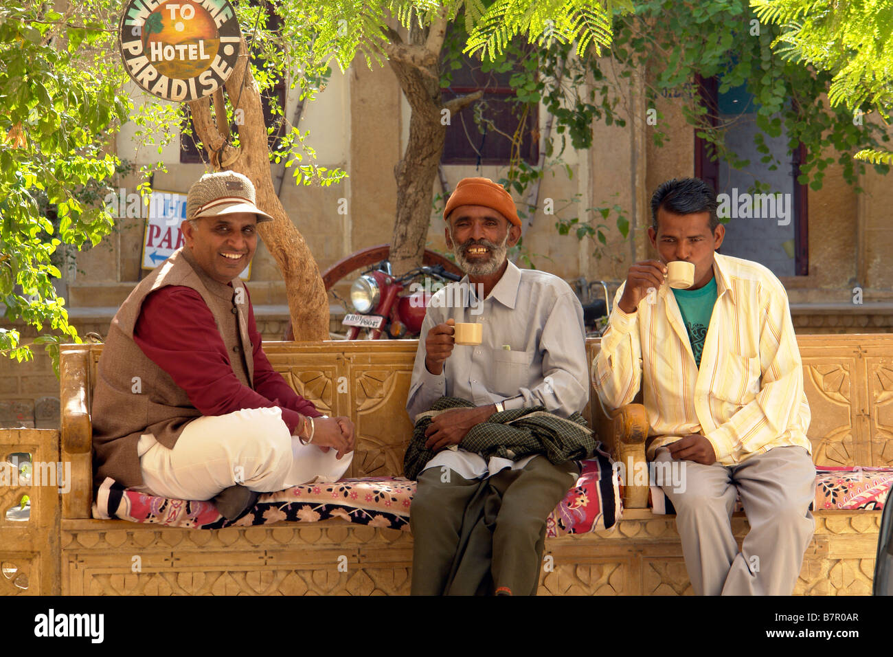 three indian men drinking tea in the backstreets of the fort at ...