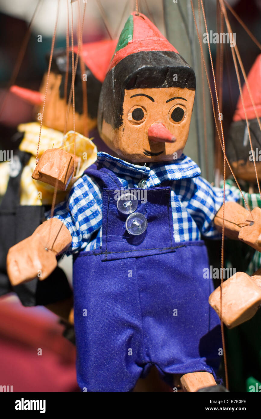 Wooden, painted Pinocchio puppets on display in a shop in Brussels ...