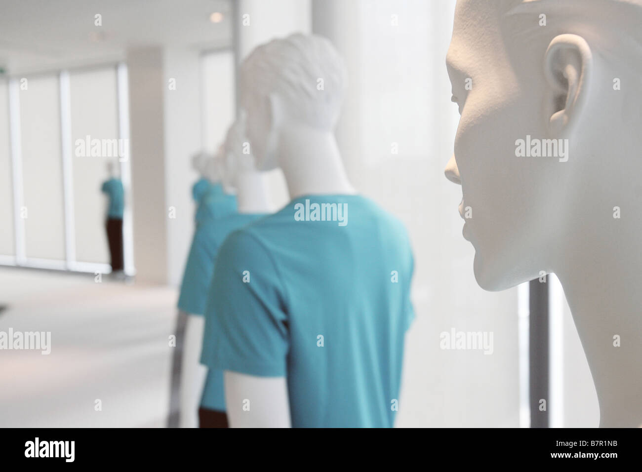 A row of Dummies in a white room Stock Photo - Alamy