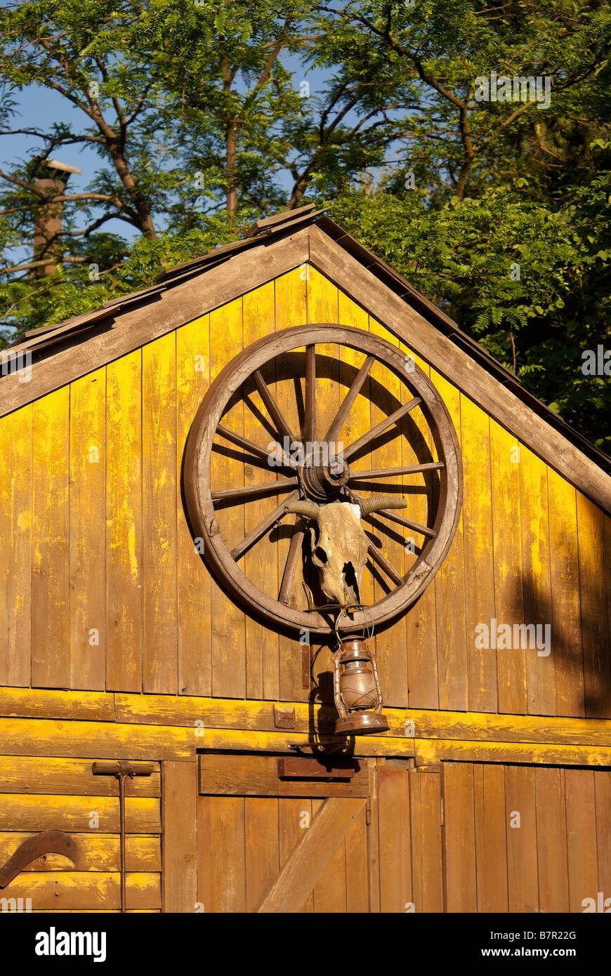 Old wooden barn with wagon wheel Stock Photo - Alamy