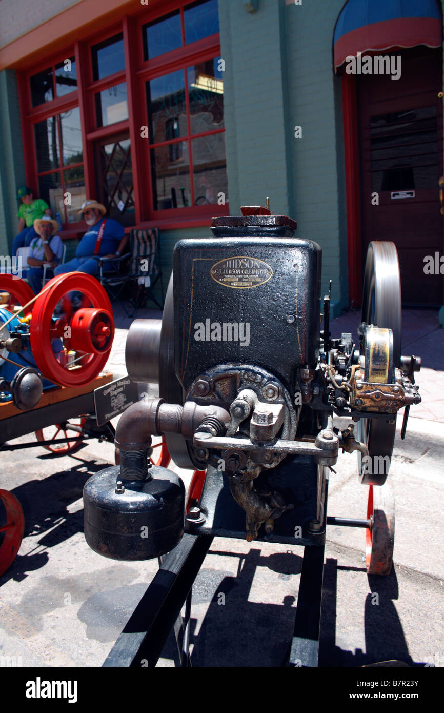 Early primitive gasoline-powered engine, operating with moving flywheel ...