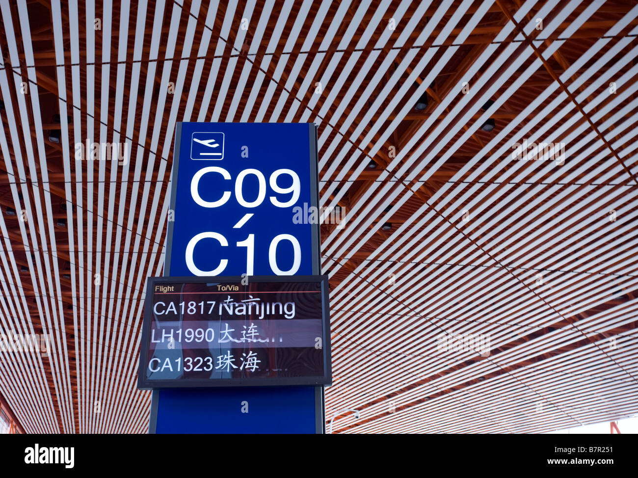 Modern departure gate information board at new Beijing Airport Terminal ...