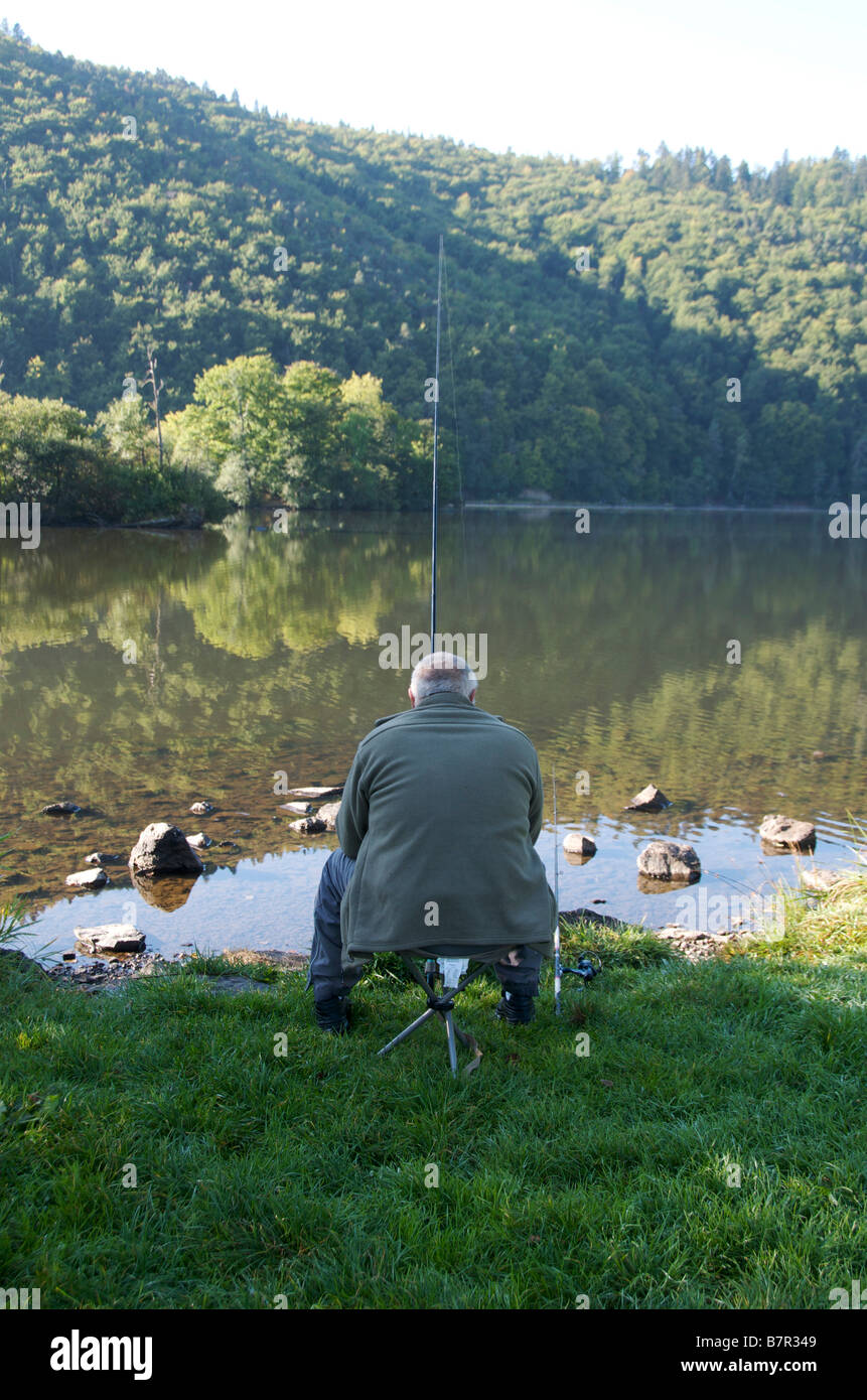 Man sitting fishing from behind hi-res stock photography and images - Alamy
