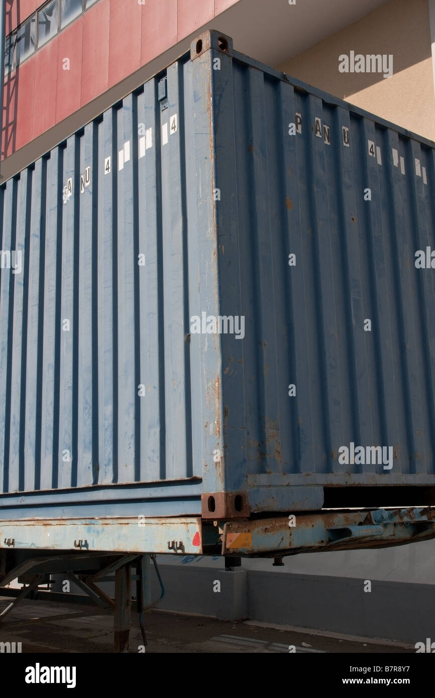 blue ship container outside of building Stock Photo - Alamy