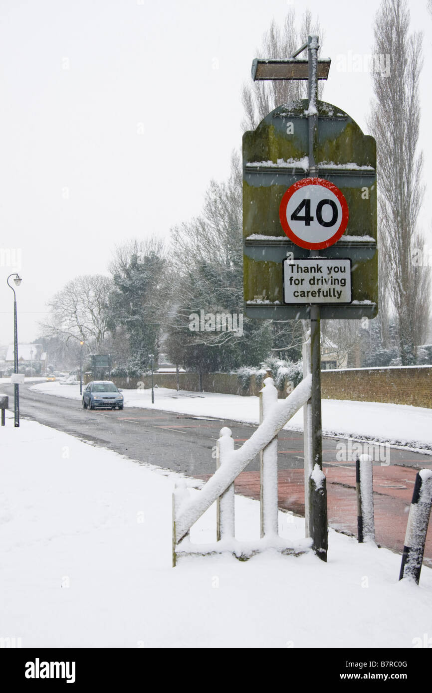 A snowy English village scene with a 40mph speed limit sign and thank ...