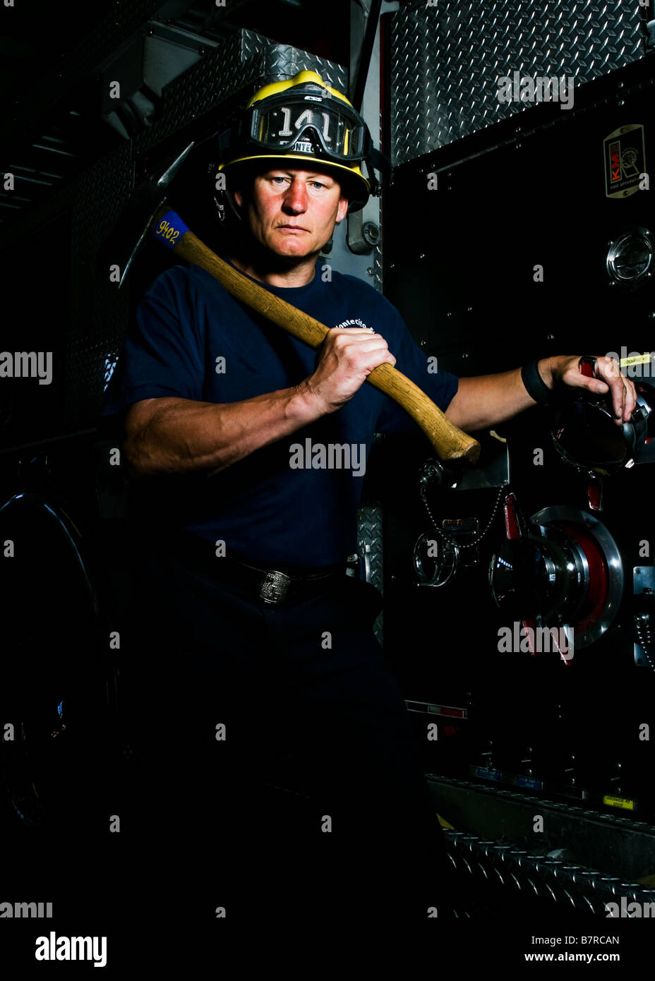 Caucasian firefighter with ax Stock Photo - Alamy
