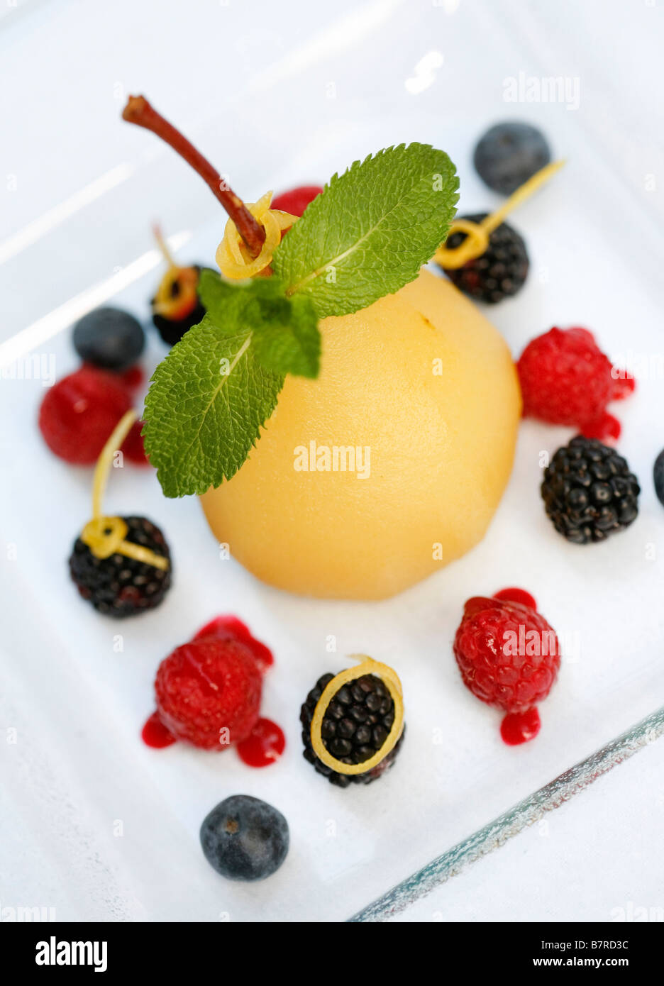 pear desert with summer fruits and coulis Stock Photo - Alamy