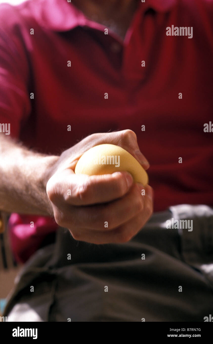 Man flexing stress ball Stock Photo - Alamy