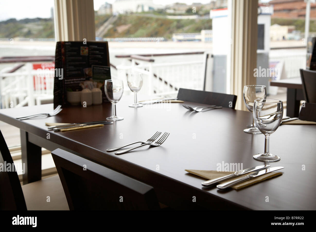 Empty table setting in West Quay on Bournemouth pier Stock Photo - Alamy