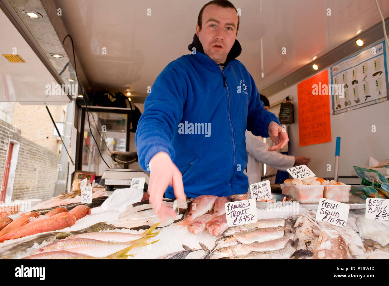 fishmonger selling his fish in street market Stock Photo - Alamy