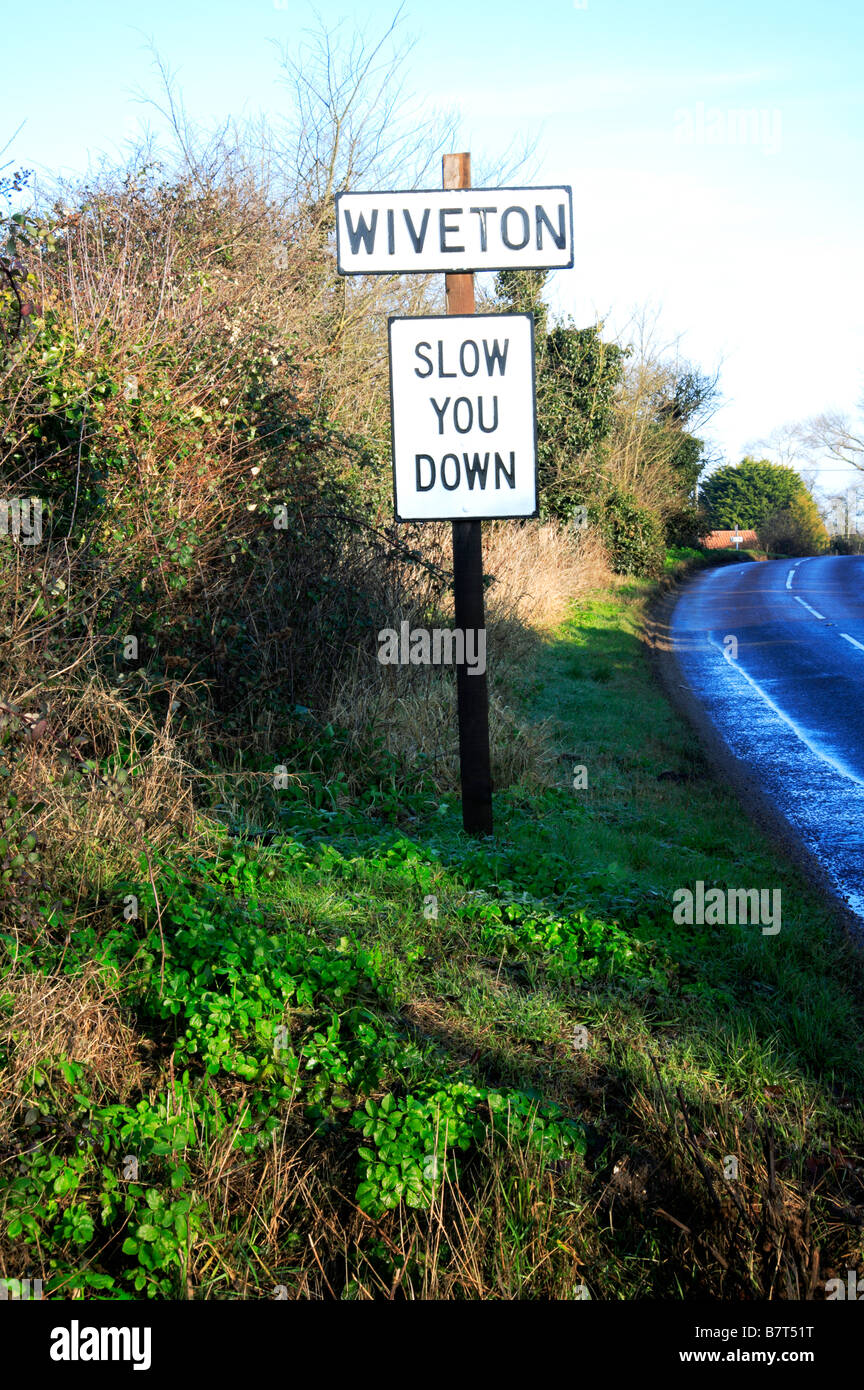 Place name and slow down sign at Wiveton, Norfolk, UK Stock Photo - Alamy
