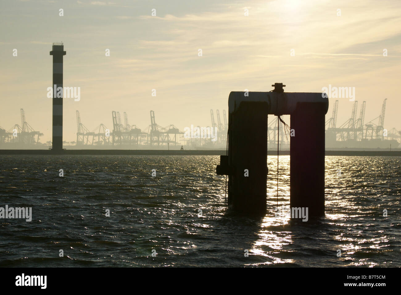 Pipeline lighthouse tower mast and ship cranes at Europort port harbour ...