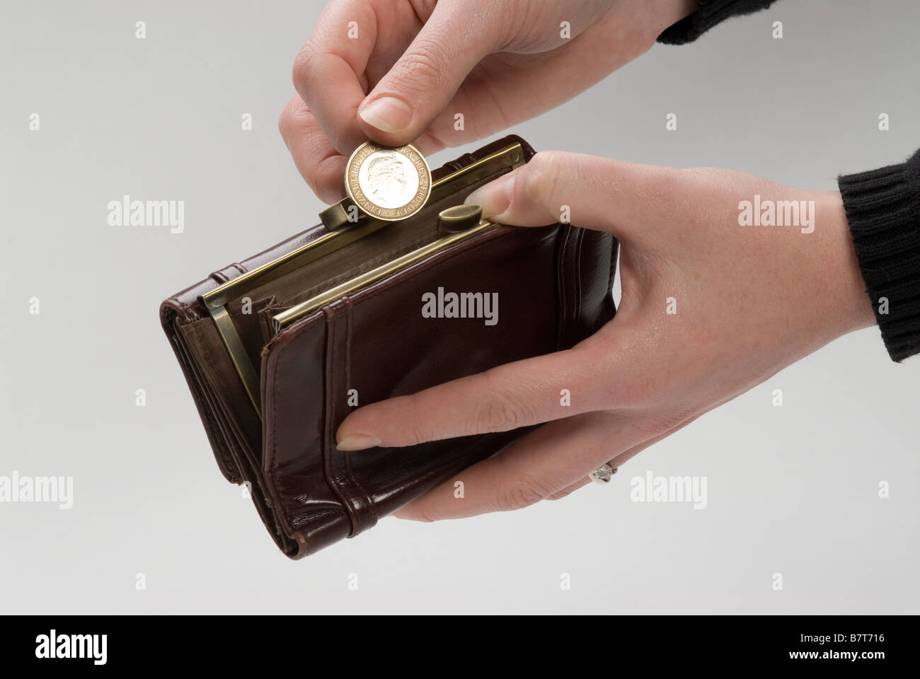Taking a coin from a purse Stock Photo - Alamy