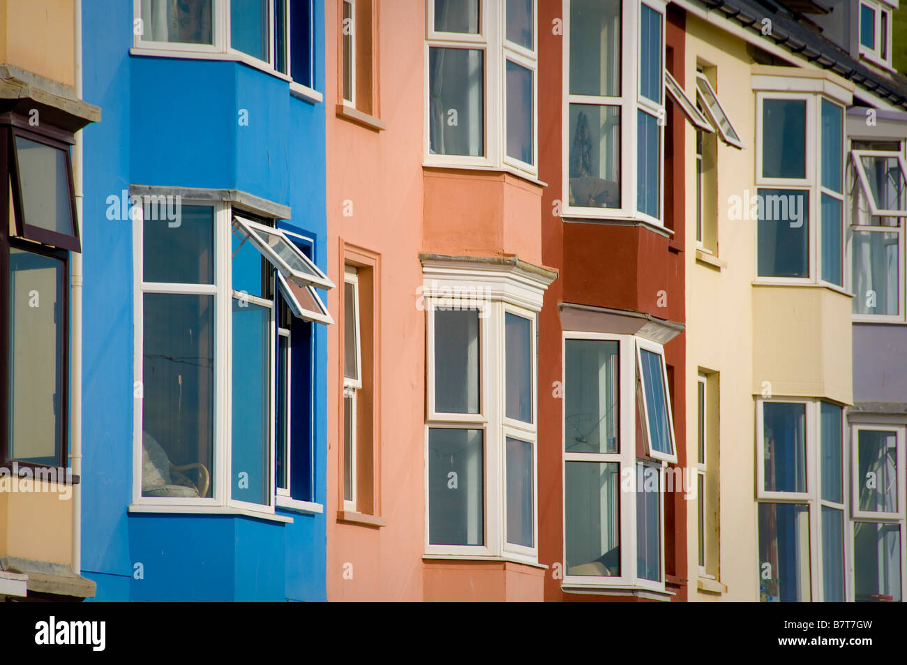 Row of terraced houses with different coloured rendering. Aberystwyth ...