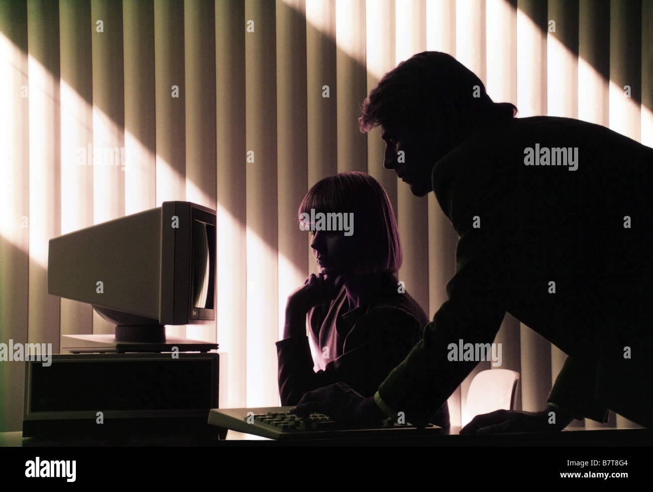 Executives at work in office setting with computer Stock Photo - Alamy