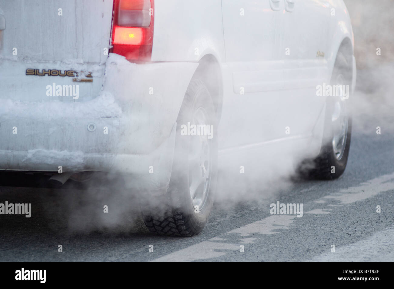 Auto emissions- tailpipe exhaust from a car driving in town, waiting in ...