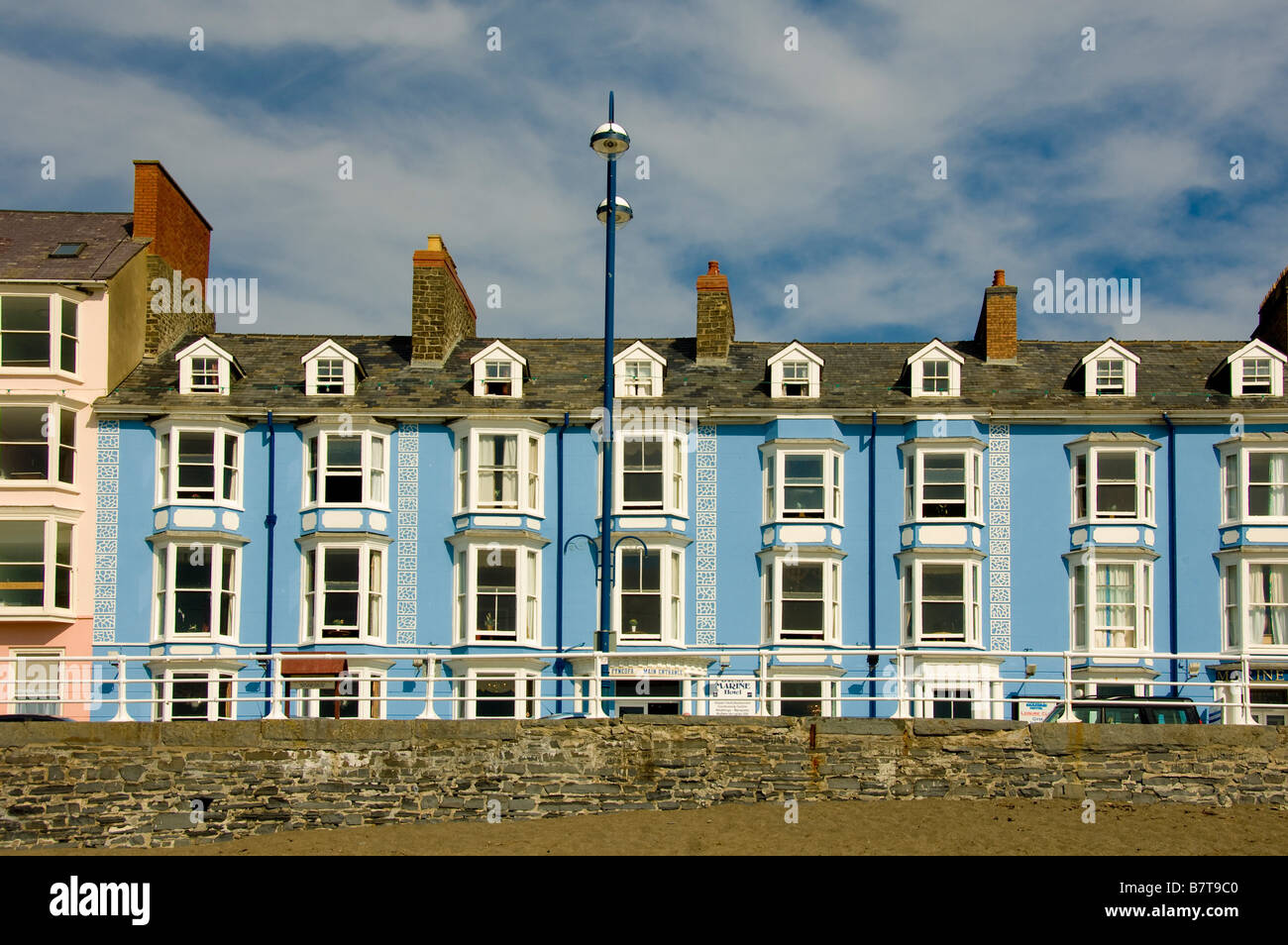 The blue and white rendered façade of Gwesty'r Marine Hotel, situated ...