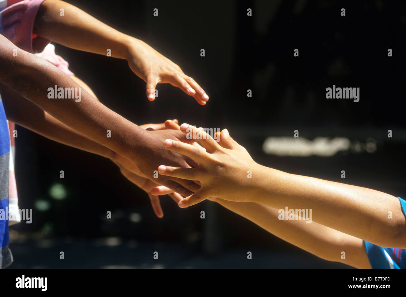 Multi-racial hands reach to touch each other Stock Photo - Alamy