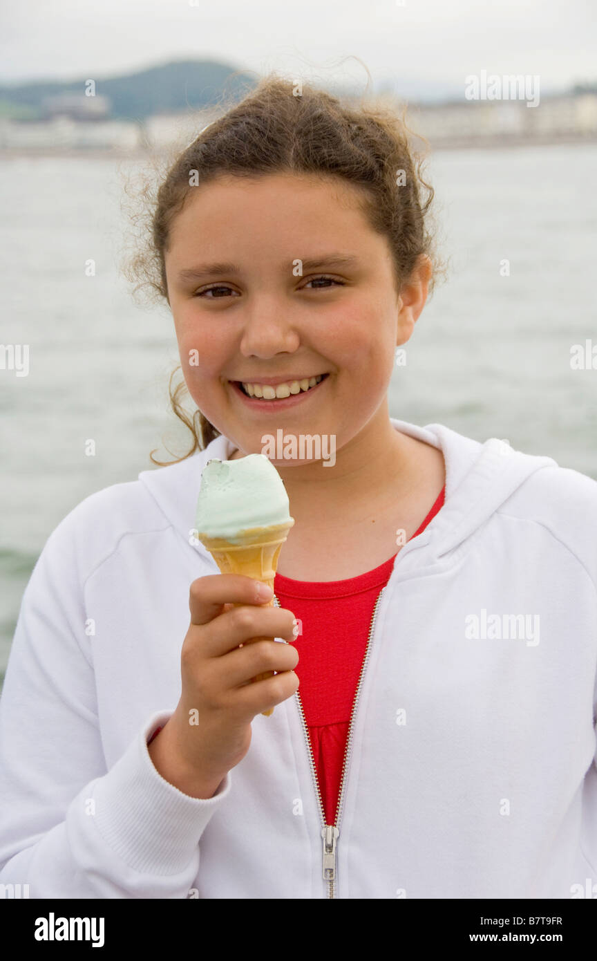 Smiling caucasian child with dark hair holding an ice cream smiling ...