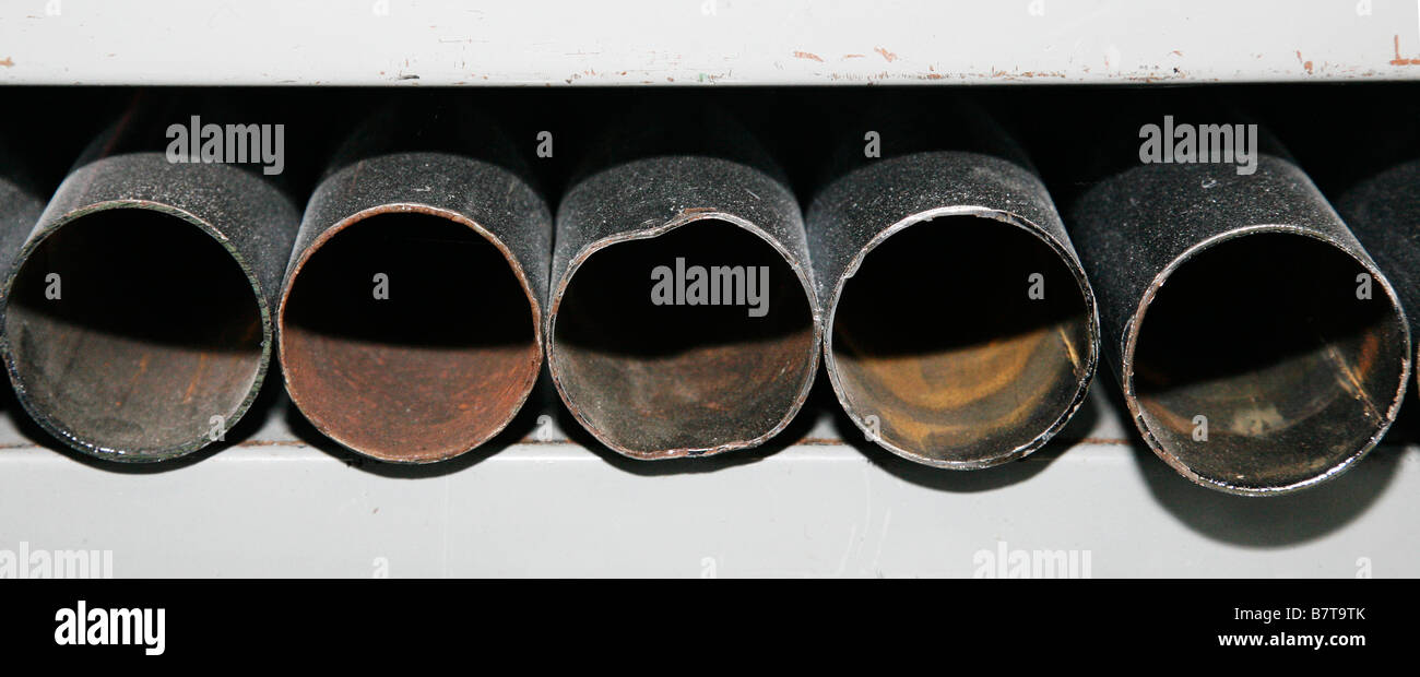 Row of metal tubes on a shelf in a warehouse Stock Photo - Alamy