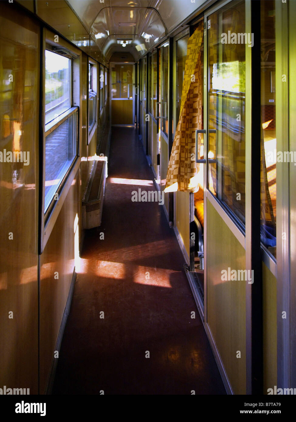 Corridor inside the rail car of a long-distance train in the east of ...