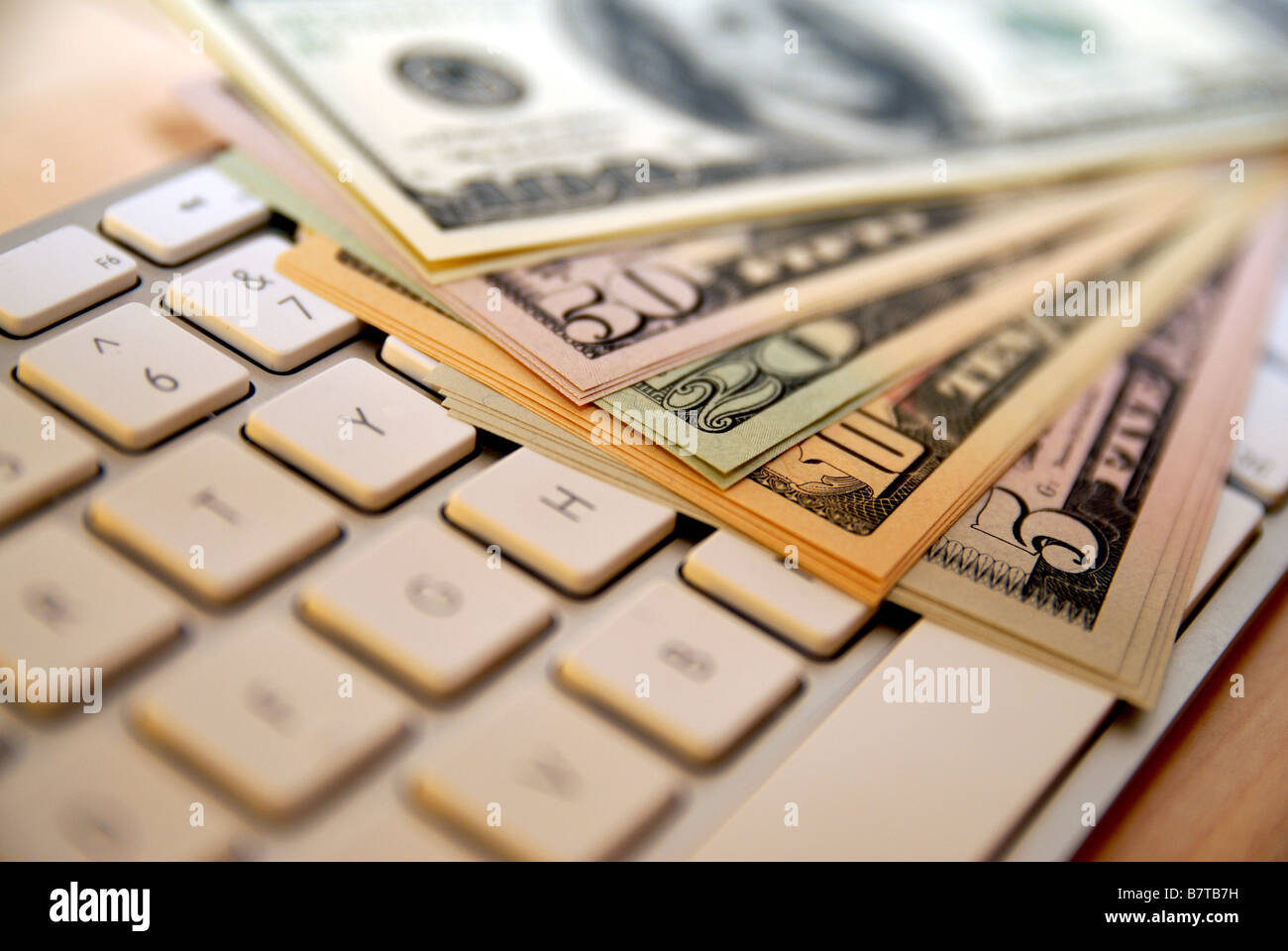 Dollar bank notes / currency / money layed out on a computer keyboard ...