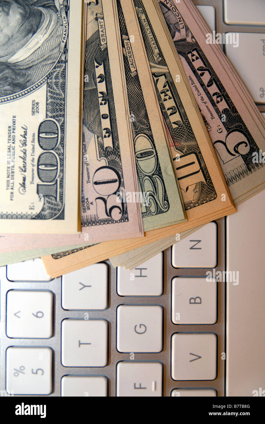 Dollar bank notes / currency / money layed out on a computer keyboard ...