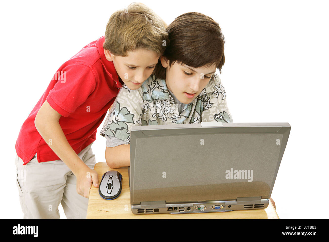Two adorable brothers using the computer together Isolated on white ...